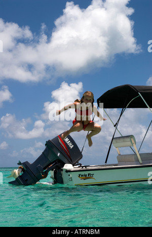 Girl jumping off of boat Rose Island Bahamas Stock Photo - Alamy