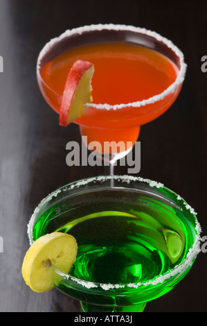 High angle view of two margarita cocktails surrounded by nachos, chips ...