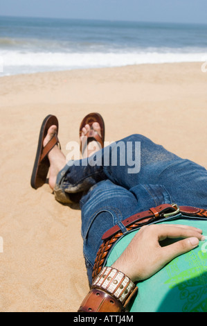 Man lying down on sand in desert Stock Photo - Alamy