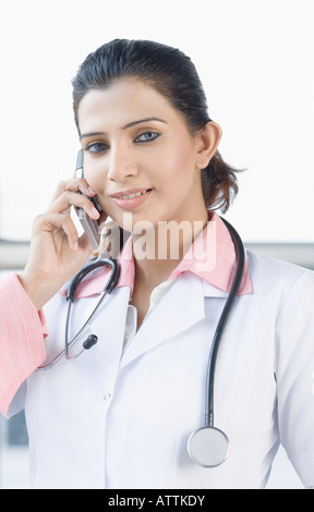 Asian female doctor talking phone holding tablet telehealth ...