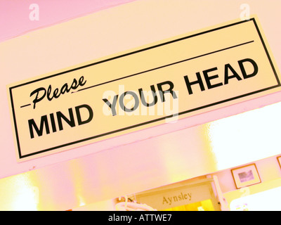 Please mind your head signage Stock Photo - Alamy