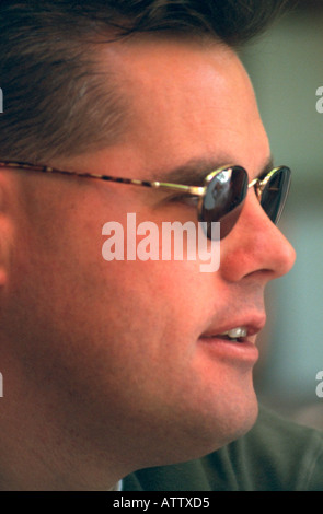 Young handsome man wearing sunglasses over isolated background looking ...