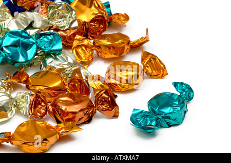 Colourful shiny paper wrapped toffee sweets on white background Stock ...