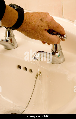 Turning off tap Stock Photo - Alamy