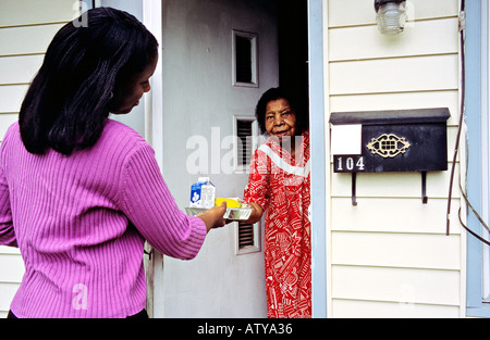 Meals on Wheels volunteer delivers meal to elderly shut in Stock Photo ...