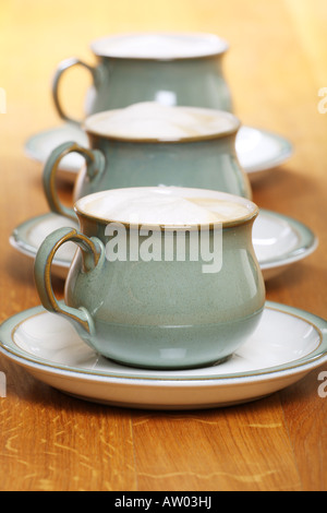 Frothy coffee in white cups, delicious French macaroons. Dessert still ...