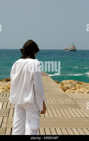Rare view of a Man on wharf watching ship leaving Stock Photo - Alamy