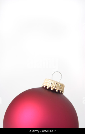 Single red frosted bauble with gold ribbon on a white background Stock ...