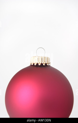 Single red frosted bauble with gold ribbon on a white background Stock ...