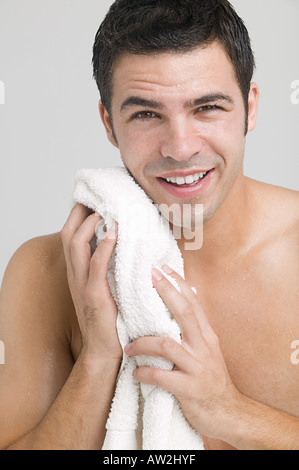 Man drying face with towel Stock Photo - Alamy