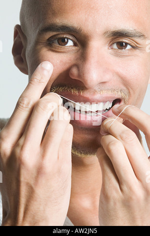 Male hand holding dental floss on white background copy space Stock ...
