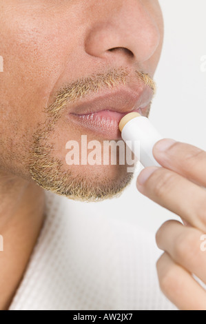 Man applying lip balm Stock Photo - Alamy