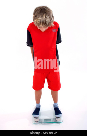 BOY ON WEIGHING SCALES Stock Photo - Alamy