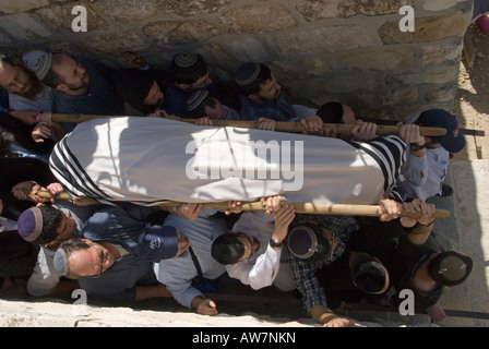 Orthodox Jews with shroud-covered body inside a funeral car ride to the ...