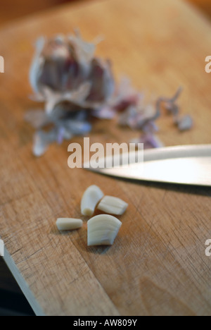 Chopping Garlic whilst preparing a meal Stock Photo - Alamy