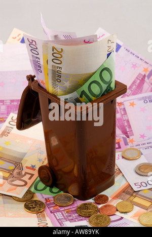Euro banknote in a garbage can as a symbol for garbage fees, waste of ...
