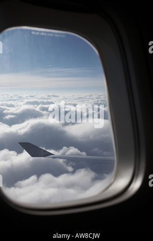 over the clouds, out of an aeroplane window Stock Photo - Alamy