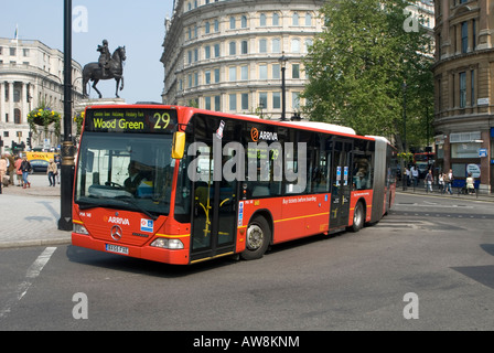 red arriva bendy bus travelling through the city of london england ...