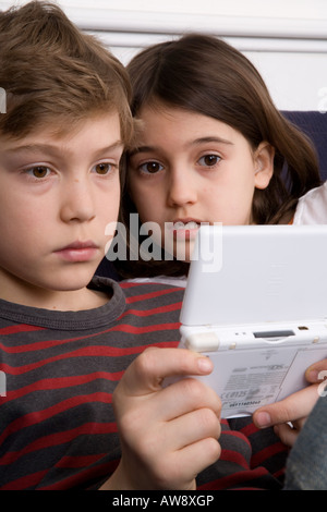 children playing with Nintendo DS Stock Photo - Alamy