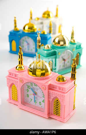 Four plastic alarm clocks in the shape of a mosque. Shot on a white ...