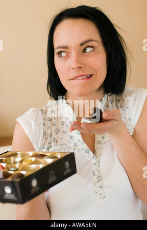 Woman with box of chocolates Stock Photo - Alamy