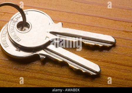 Pair of house keys on wooden table Stock Photo - Alamy