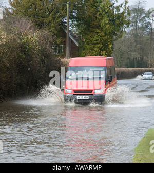 Van driving through flooded road making a splash, ashford, kent, uk ...