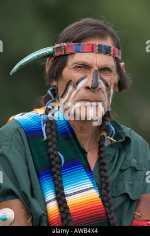 Warrior in Comanche clothing and war paint riding on white horse Stock ...