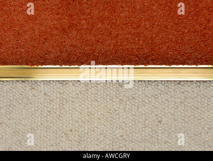 Gold aluminium carpet edging door strip between red and cream carpets ...