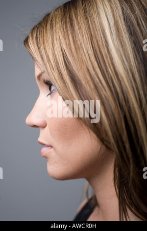 Attractive blond women looking left wearing black sports top isolated ...