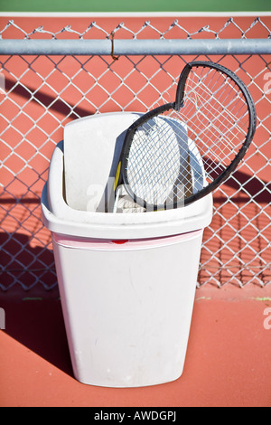 Broken tennis racket in trash receptacle on court Stock Photo - Alamy