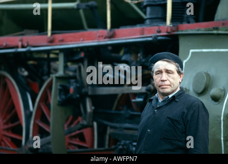 Sasha, a russian train driver standing next to a Type SU steam ...