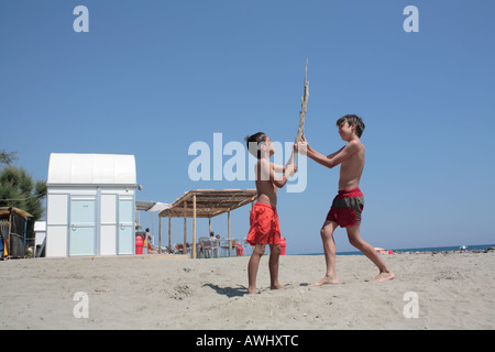 two boys playing knight on beach 8-12 years Stock Photo - Alamy