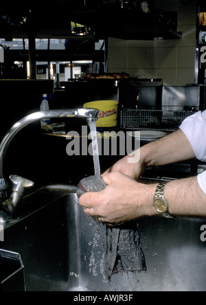 A man with a rag in his hand washes the wall inside the room Stock ...