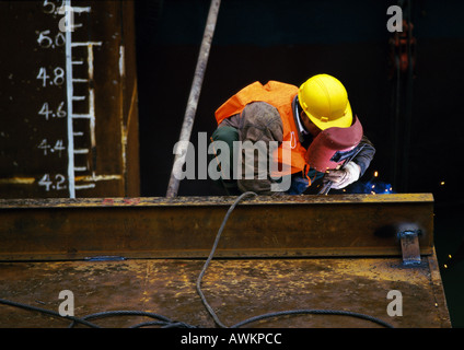 Skilled construction worker wearing protective gloves carefully ...