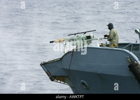 Harpoonist with harpoon aboard Japanese whaling ship, Southern Ocean ...