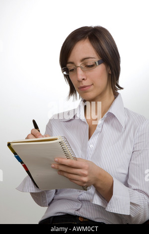 Female secretary jotting down notes on writing pad Stock Photo - Alamy