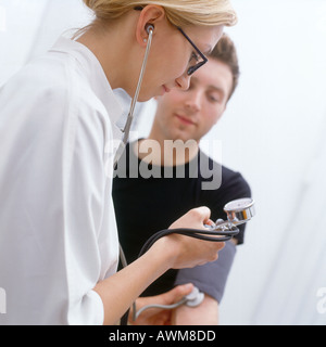 Female doctor checking man's pulse in clinic, closeup Stock Photo - Alamy