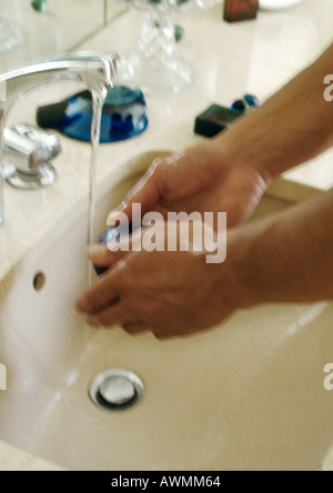 Man's hands washing under the tap a kitchen knife Stock Photo - Alamy