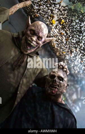 Creepy monster wearing scary mask with fake blood and stringy hair ...