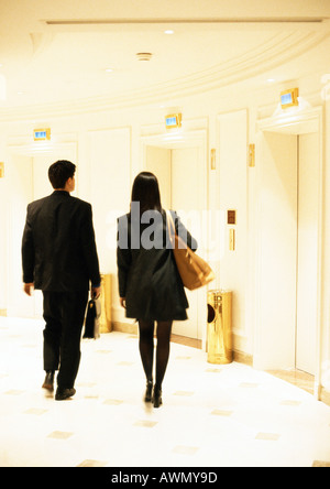 Wide-shot of two women walking by The Serpentine at Hyde Park at sunset ...