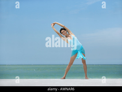 Women in swimsuits lean on the railing of a footbridge. The woman on ...