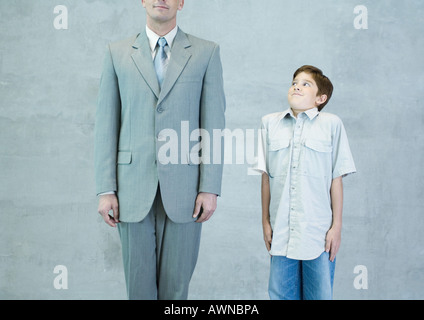 Boy imitating as a businessman and standing with his father Stock Photo ...