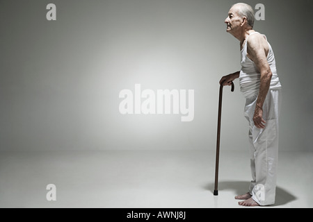 An old man using a walking stick Stock Photo - Alamy