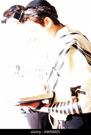 Side view of Jewish man reading beside wall, Jewish Quarter, Jerusalem ...