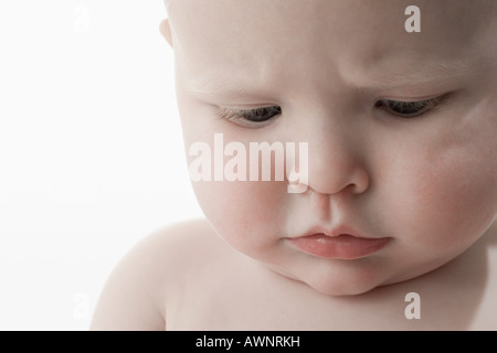 Close-up portrait of sad baby boy against gray background Stock Photo ...