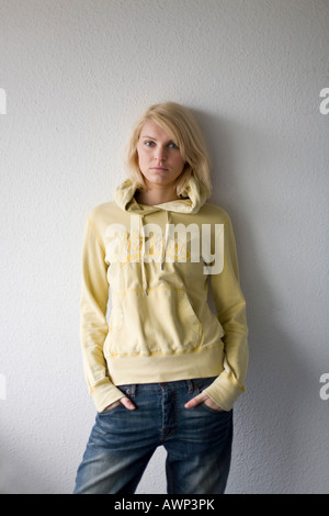 Thoughtful young blond woman glancing sideways Stock Photo - Alamy