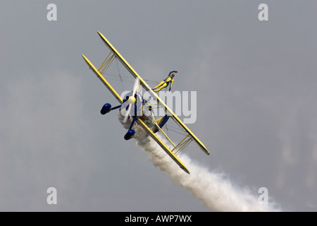 A Boeing PT17 Stearman biplane displaying with a wing walker between ...