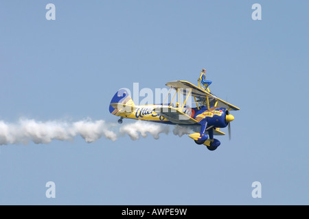 A Boeing PT17 Stearman biplane displaying with a wing walker between ...