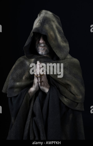 Praying monk in frock with rosary Stock Photo - Alamy
